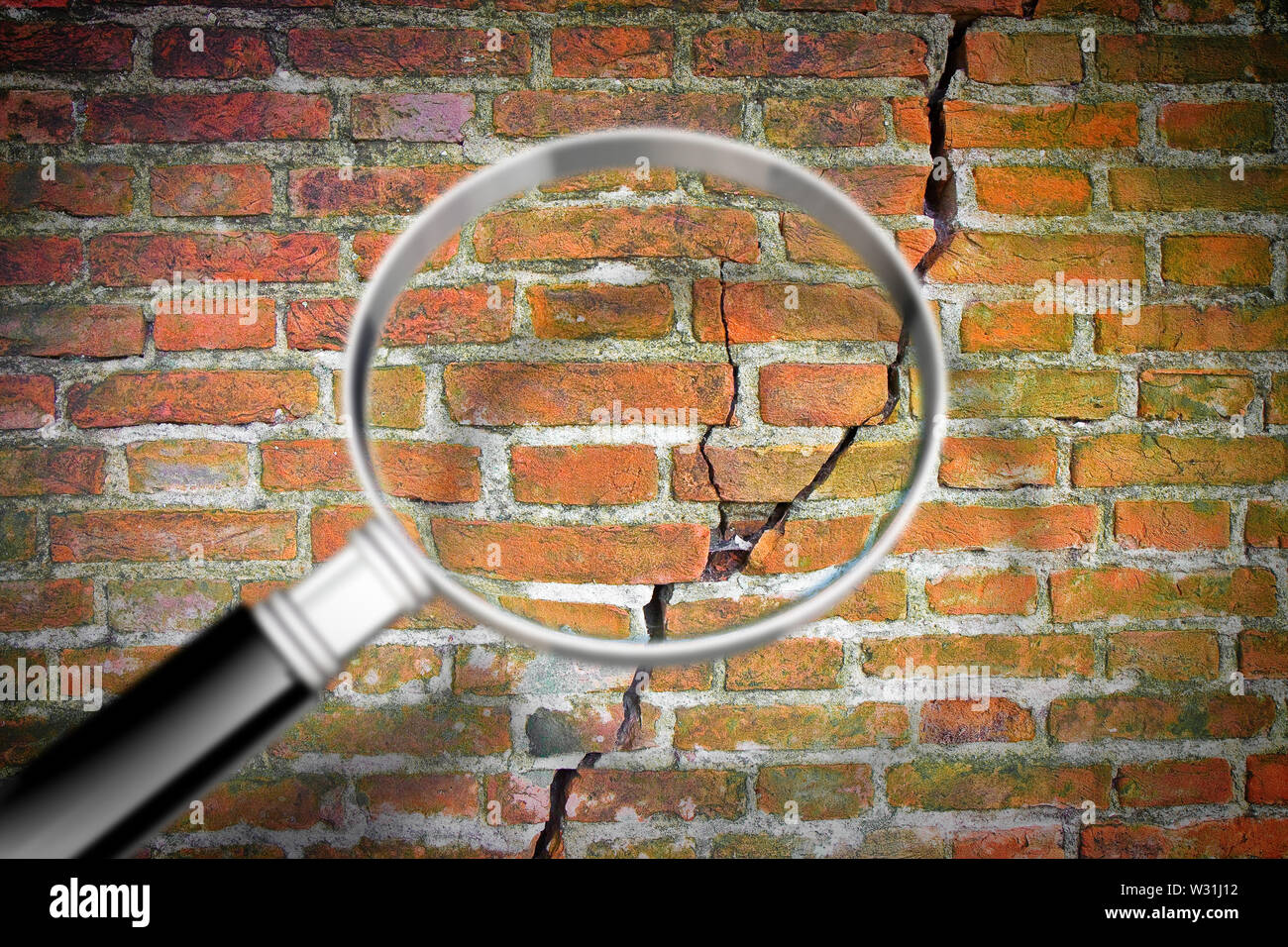 Deep crack in old brick wall with magnifying glass - concept image ...
