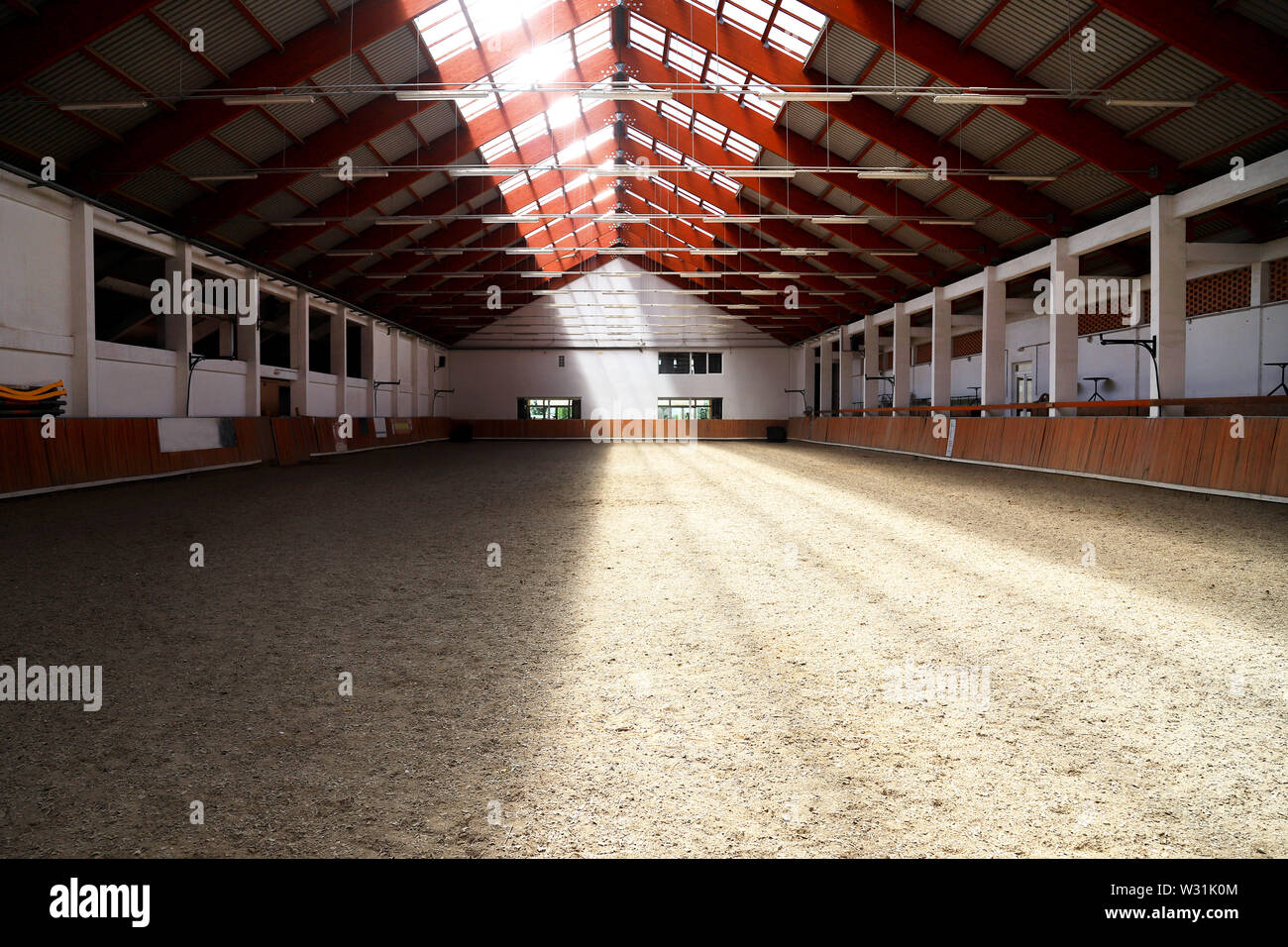Picture of an empty indoor horse riding hall. Horizontal view in an ...