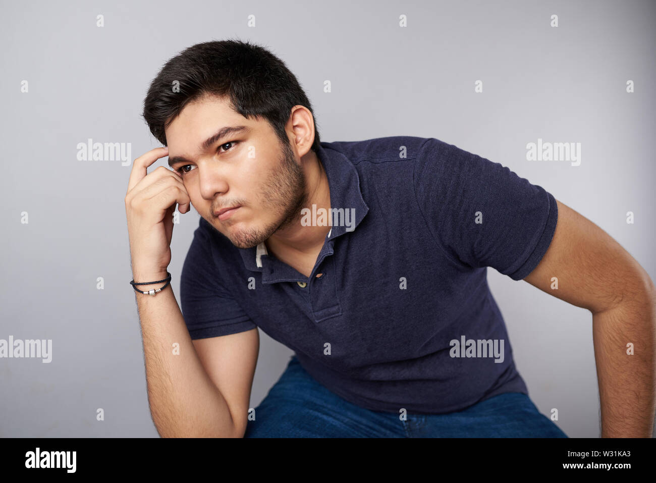 Worried young man portrait isolated on gray studio background Stock ...