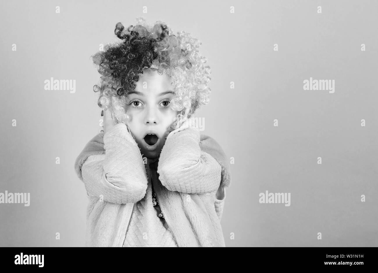 Wearing the foolish clown face. Surprised small clown with opened mouth ...