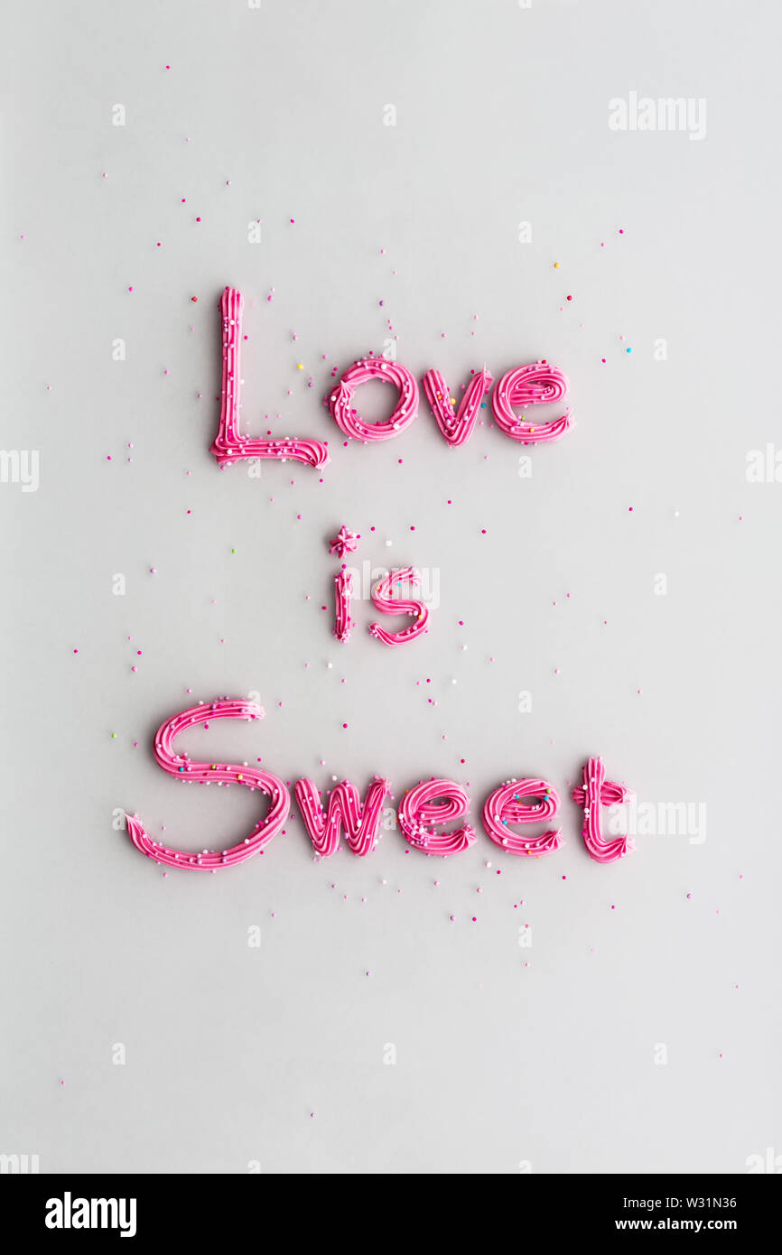 Love is sweet written in buttercream frosting Stock Photo - Alamy