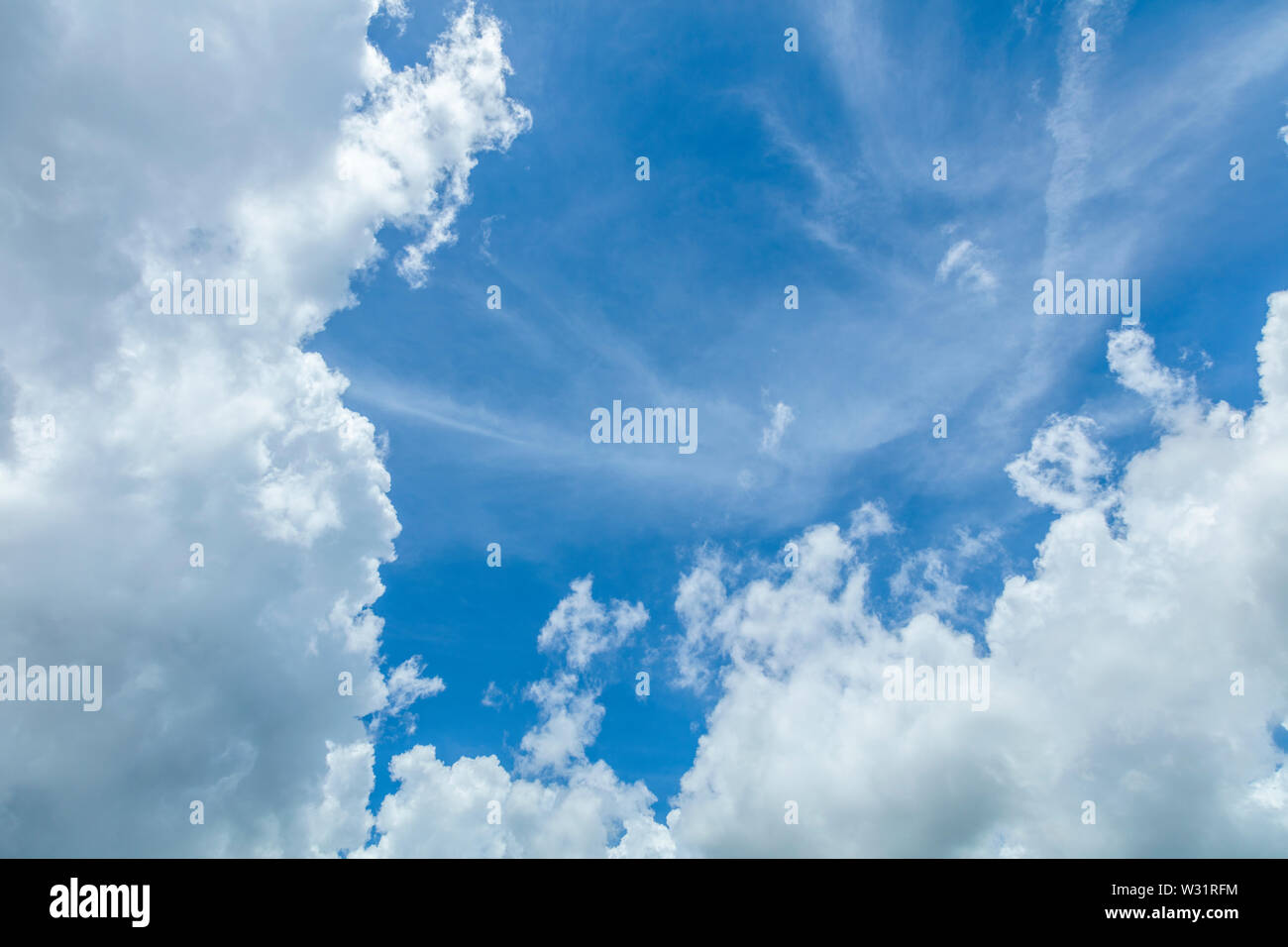 Big white clouds surrounding an area of blue sky Stock Photo - Alamy
