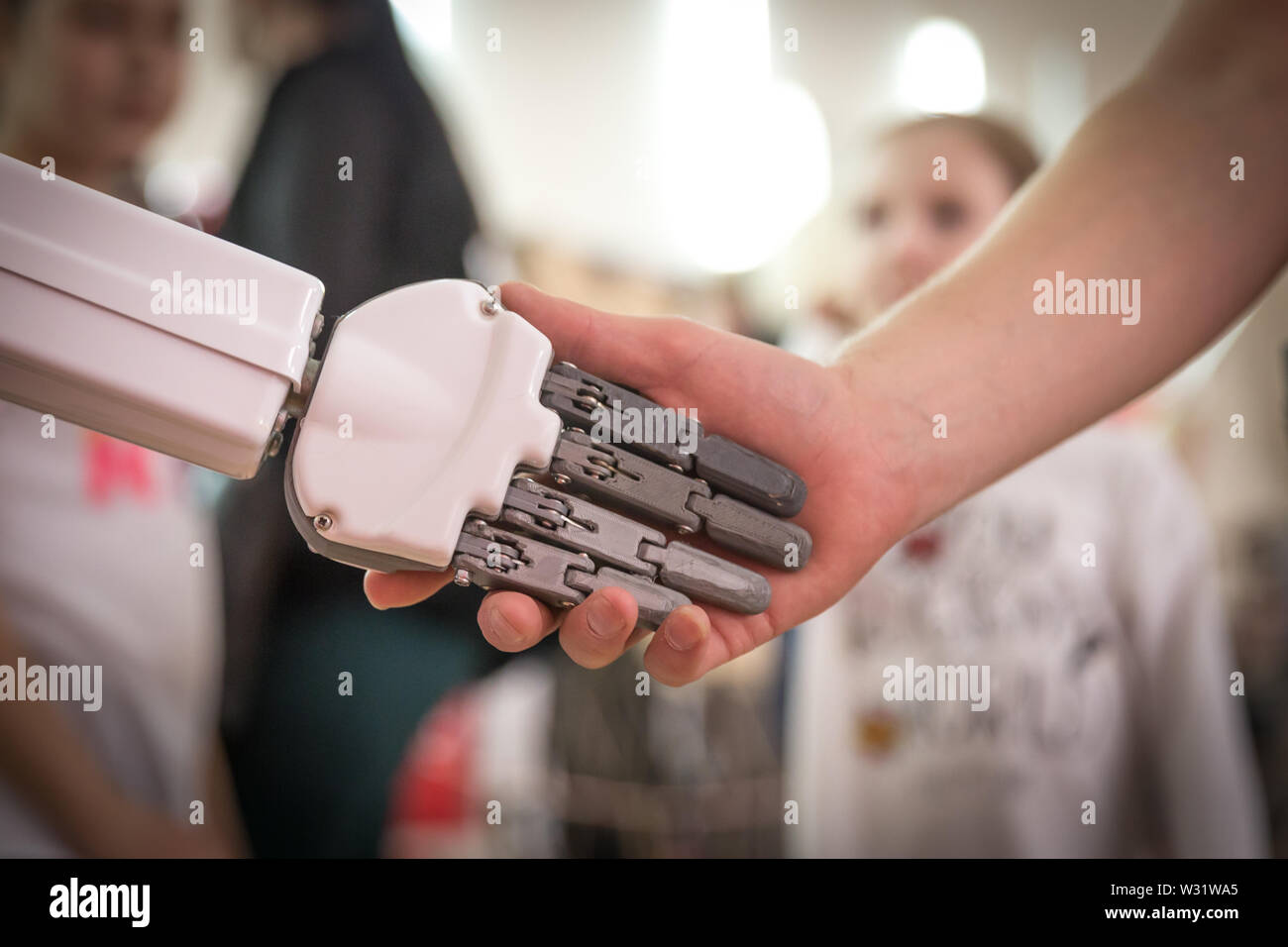 Man and robot handshake in a crowd. Concept of human interaction with ...