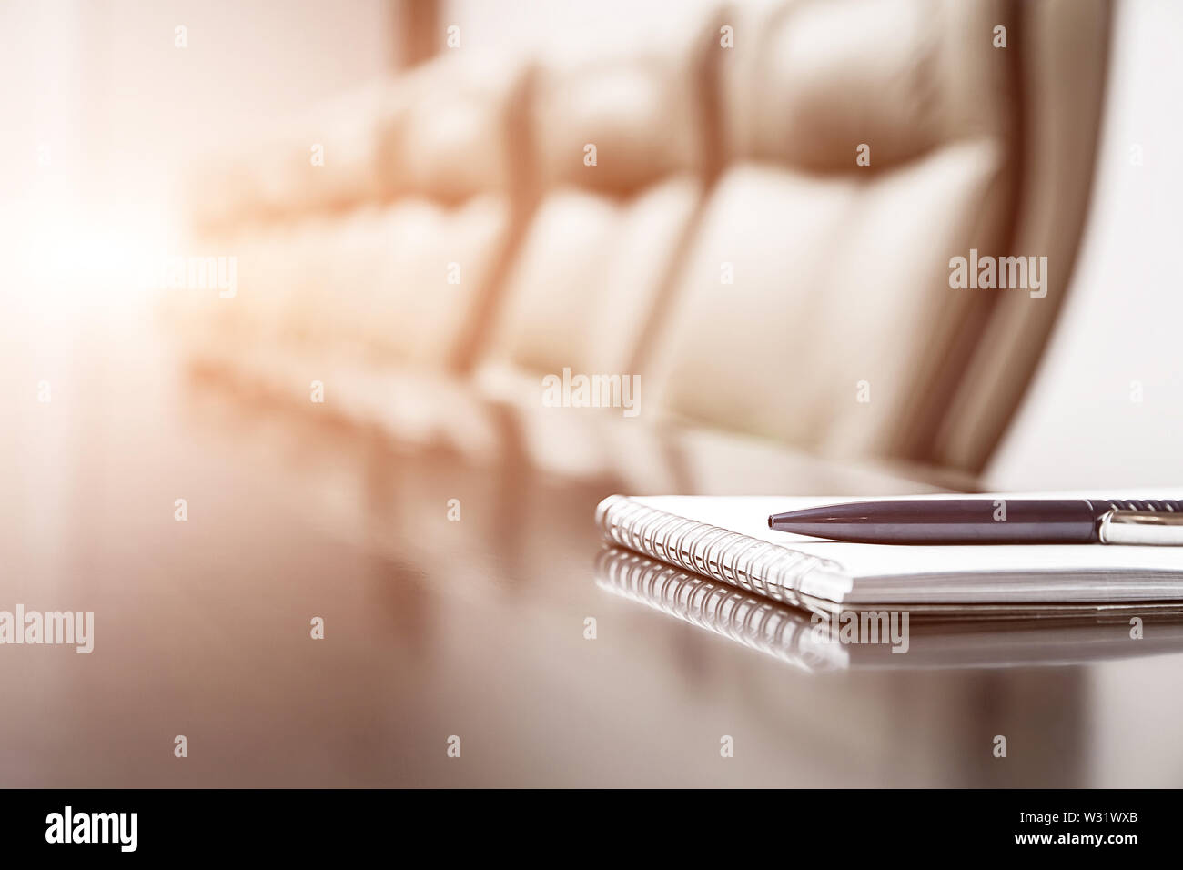Notepad kept on table in empty conference room Stock Photo - Alamy