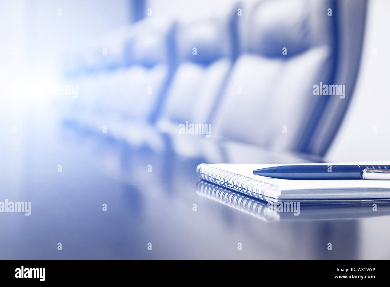 Notepad kept on table in empty conference room Stock Photo - Alamy