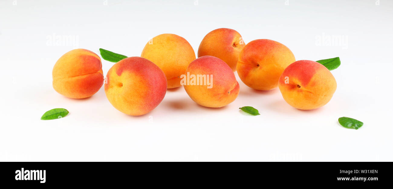 Fresh apricots with green leaves isolated on white background Stock ...