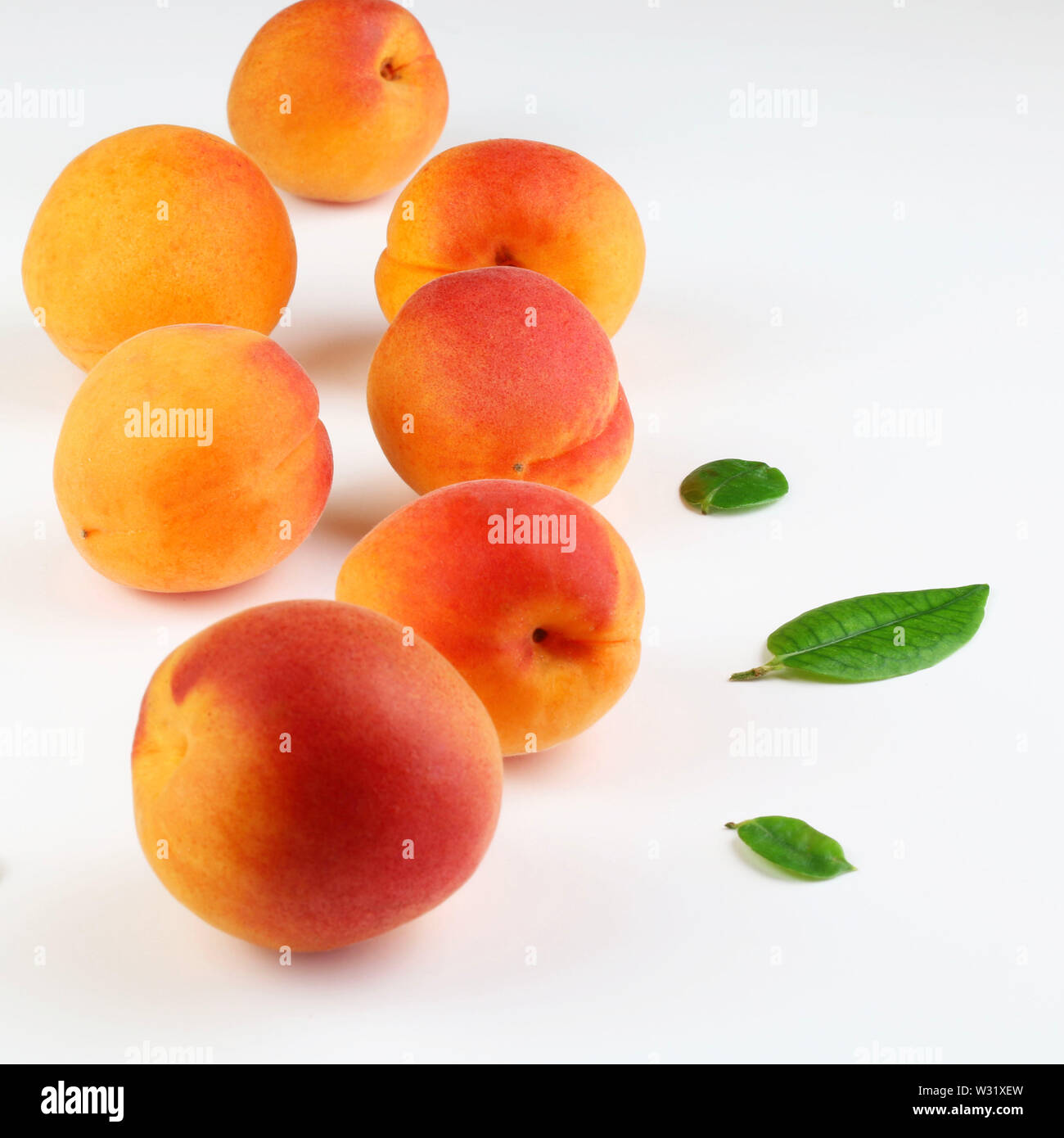 Fresh apricots with green leaves isolated on white background Stock ...