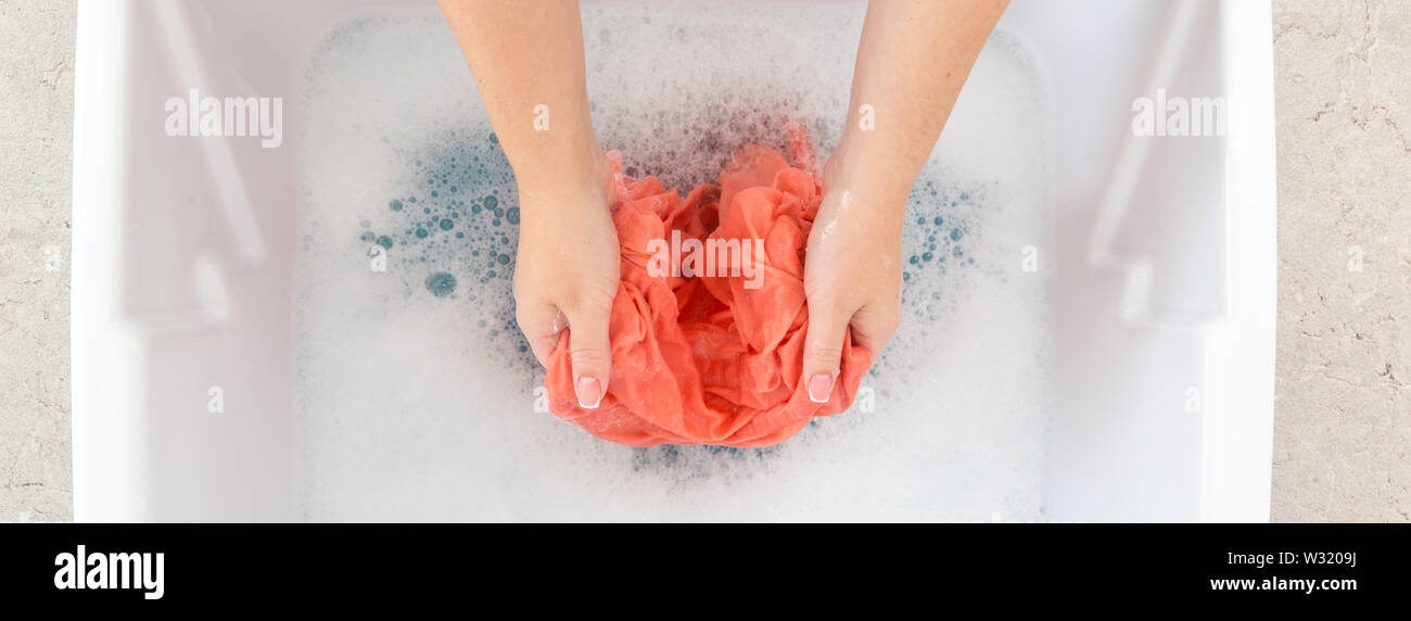 Washing clothes in sink hi-res stock photography and images - Alamy
