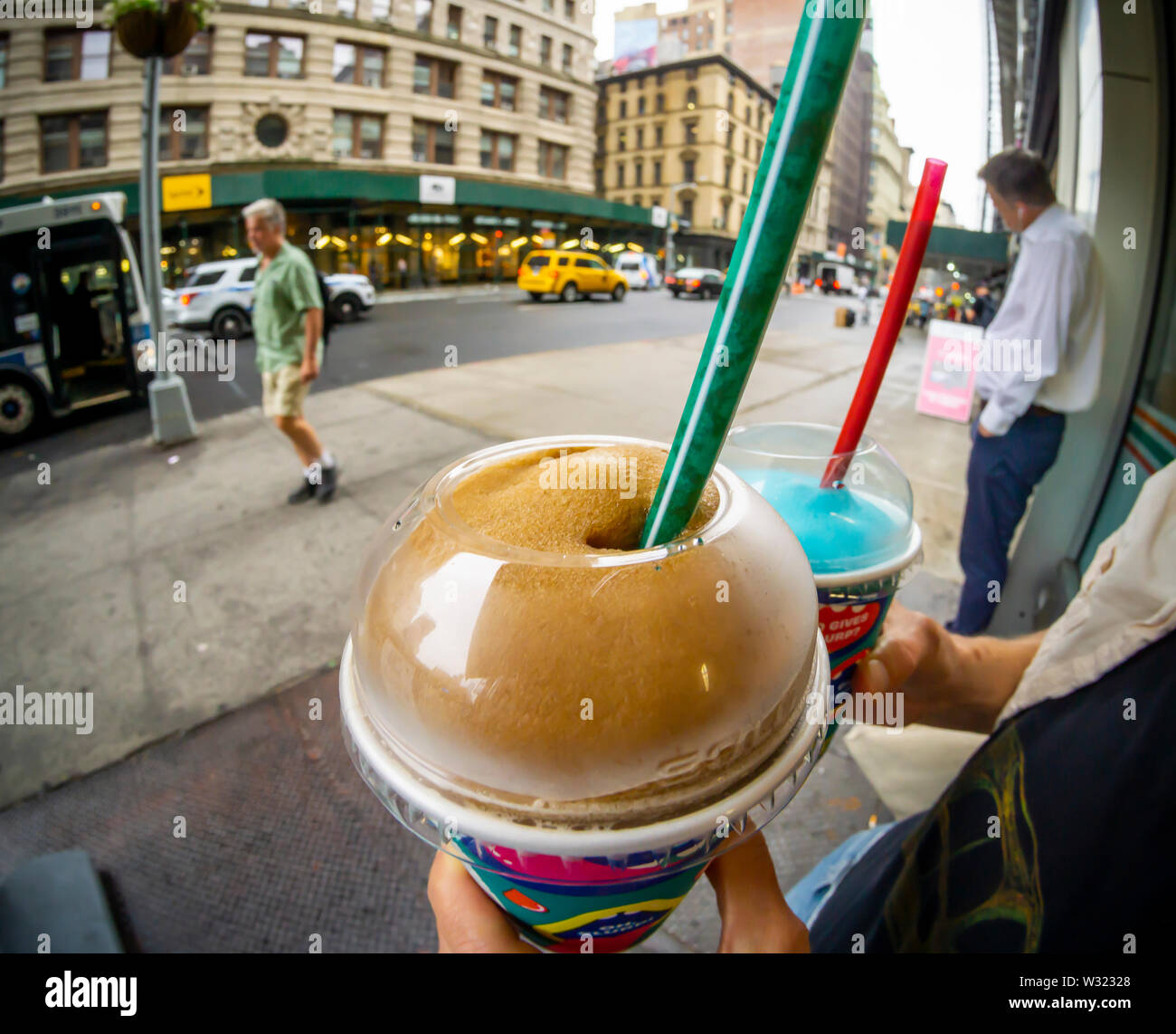 A slurpee lover displays her free Slurpees outside a 7-Eleven store in ...