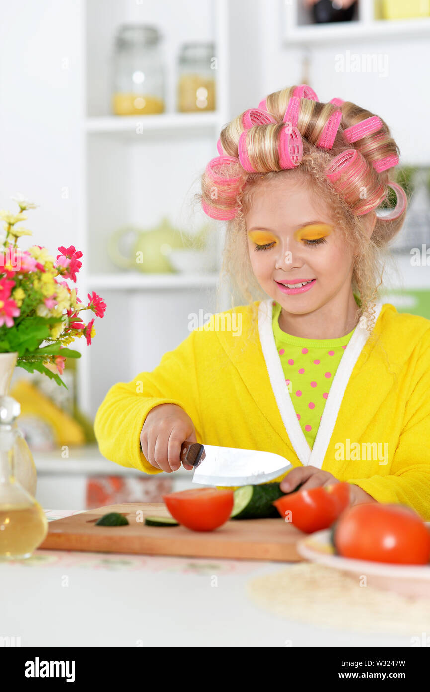 Portrait of cute little girl with hair curlers Stock Photo - Alamy