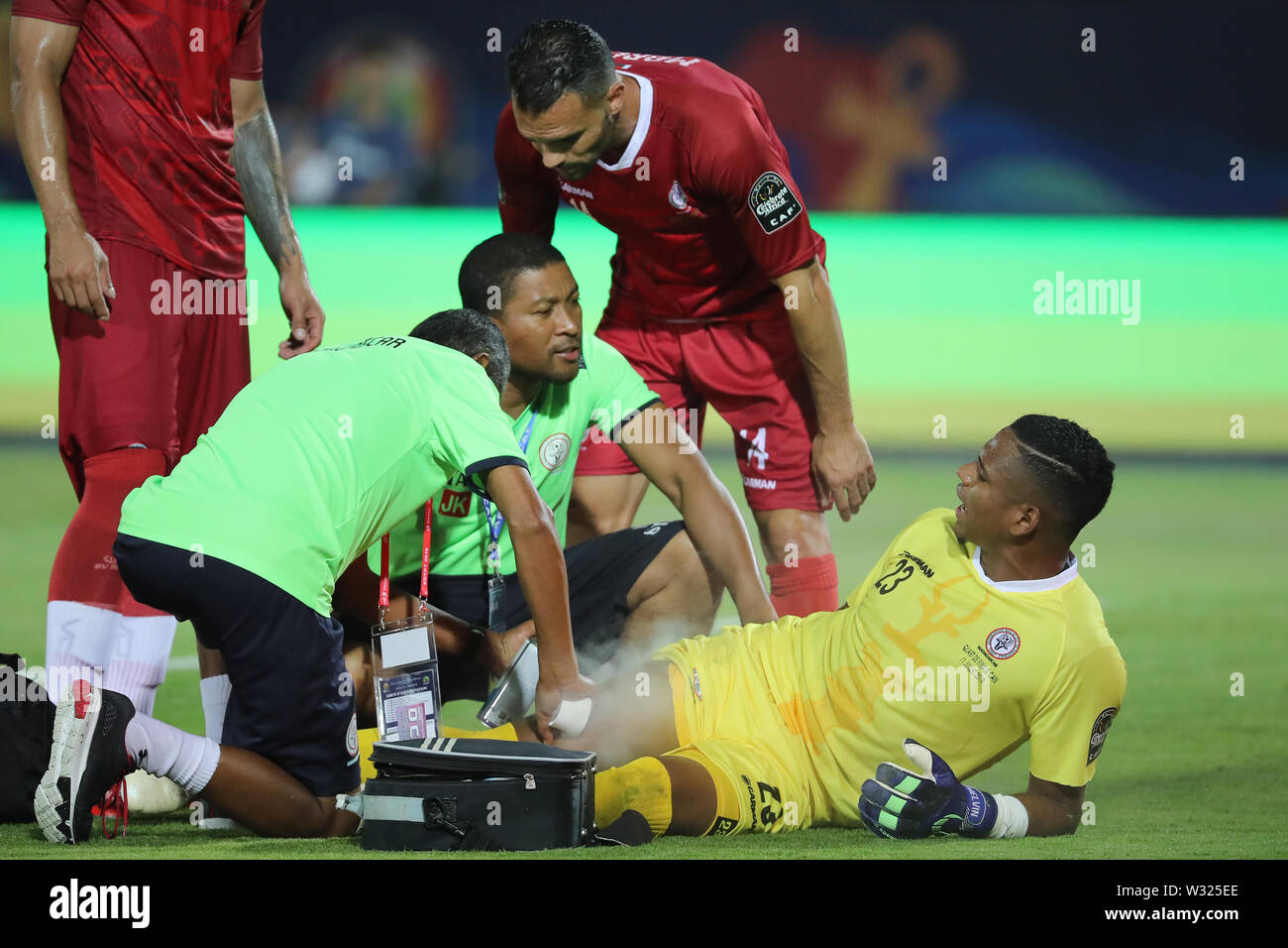 11 July 2019, Egypt, Cairo: Madagascar's Melvin Adrien (R) gets his ...