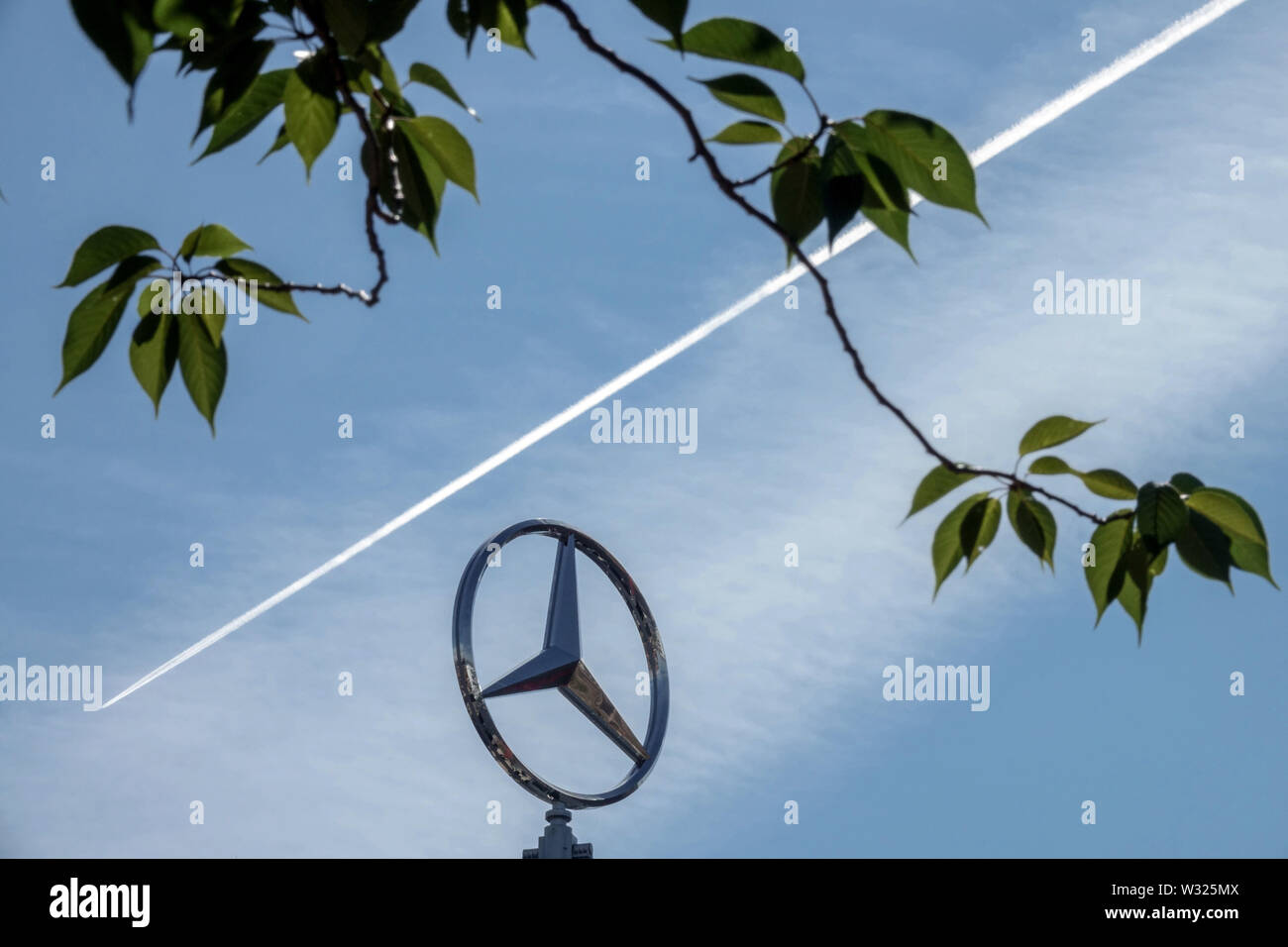 Mercedes Benz logo on building, headquarters, sky, and leaves, Berlin ...