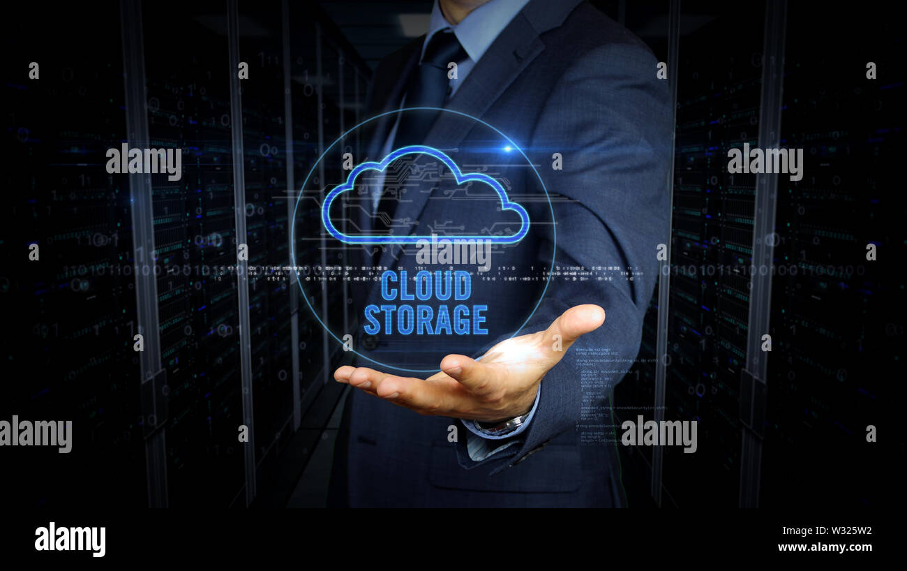 A businessman in a suit touch the screen with cloud symbol hologram ...