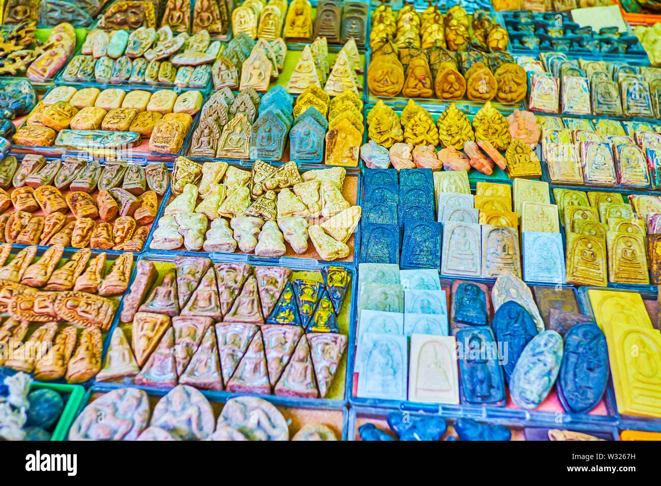 The variety of amulents from different materials on buddhist theme in ...