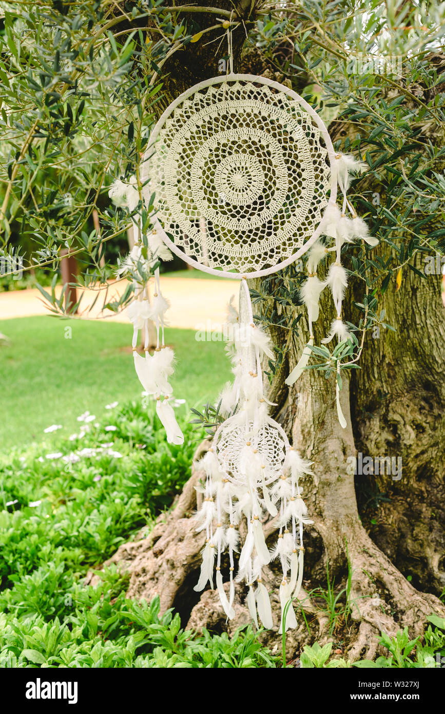 Decoration embroidered with white thread hanging from an olive tree ...