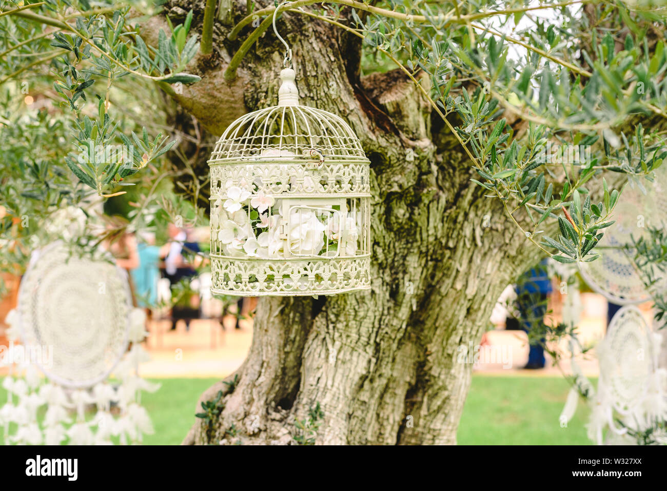 Decoration embroidered with white thread hanging from an olive tree ...
