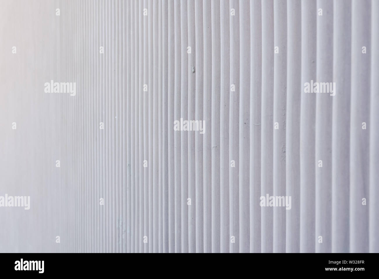 Wavy metal background on a gray wall Stock Photo - Alamy