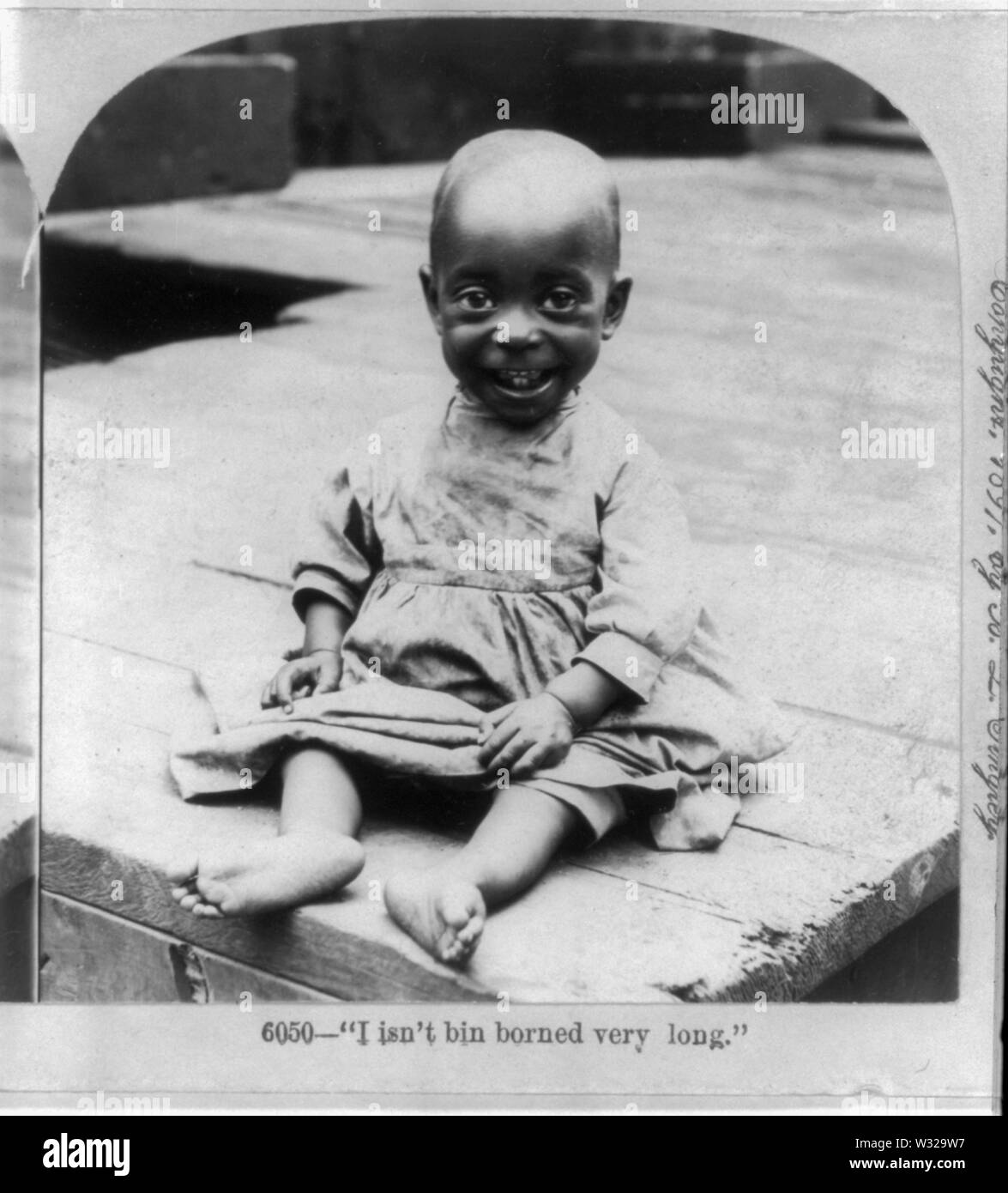 Small child seated Stock Photo - Alamy