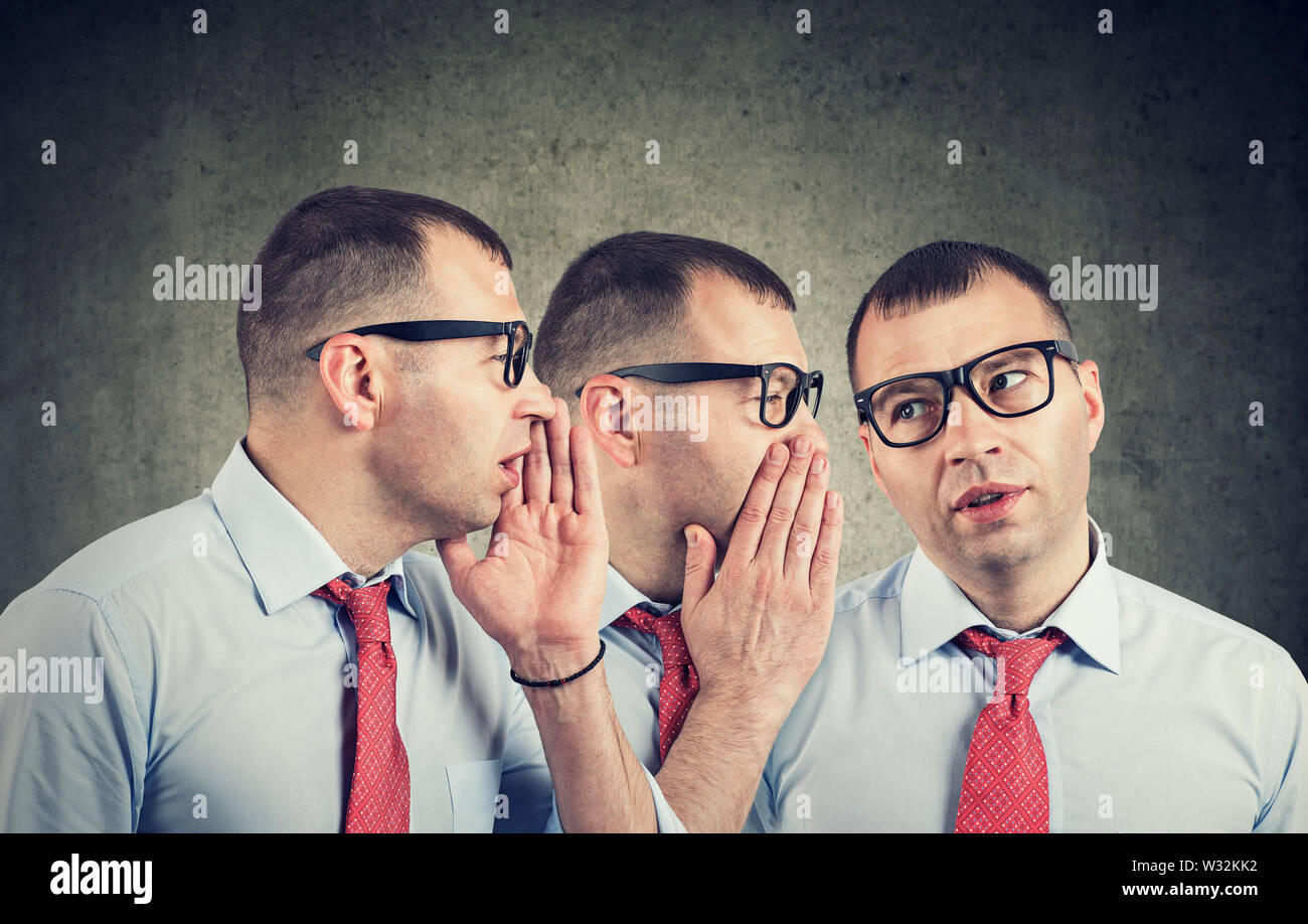 young business man self whispering in the ear Stock Photo - Alamy