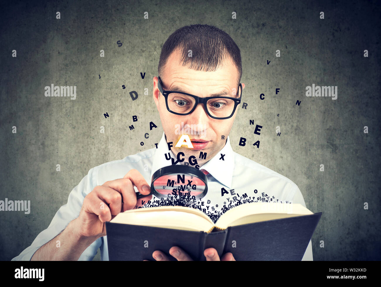 Amazed man using magnifying glass reading a book with letters flying ...