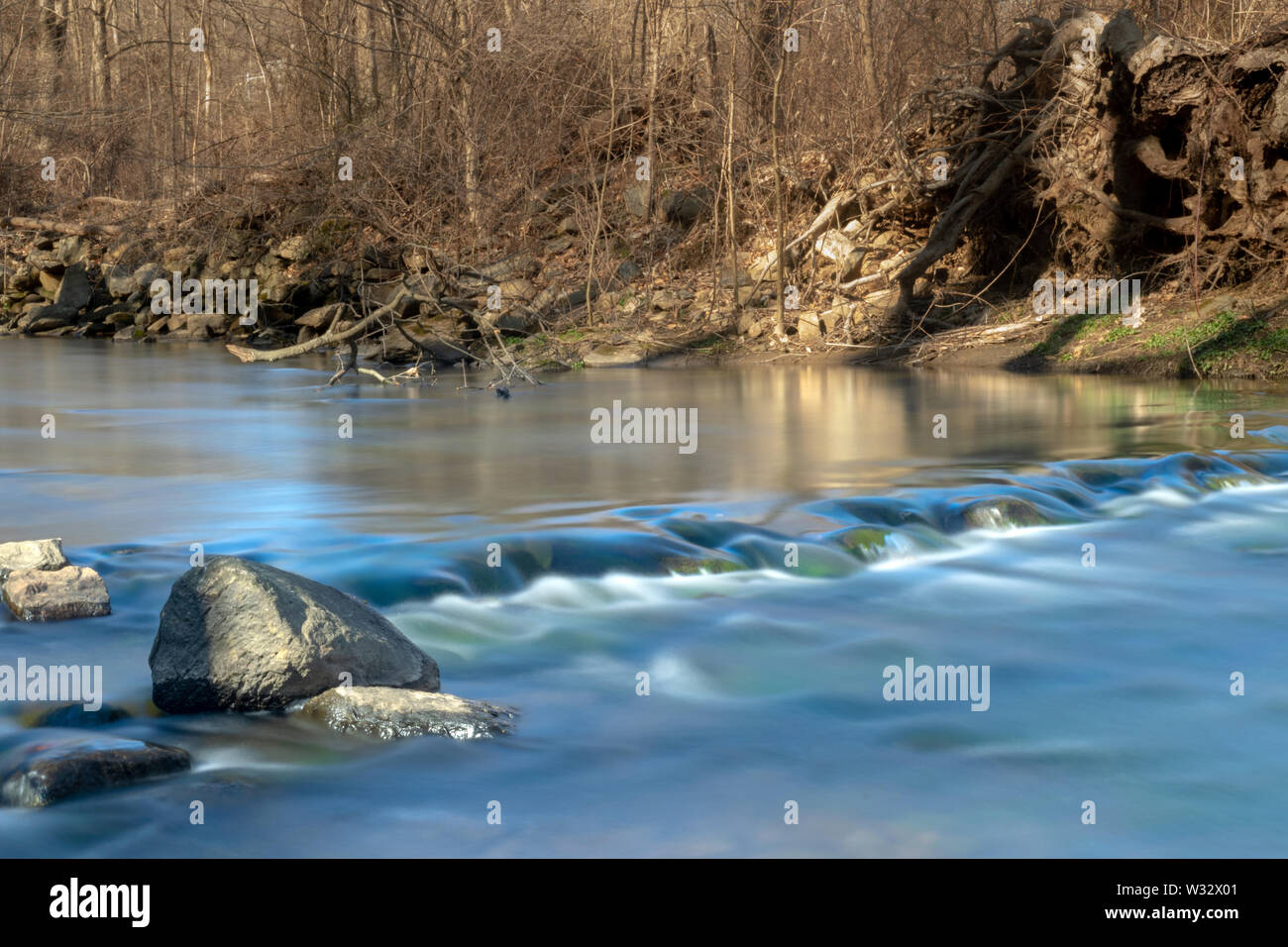 Long exposure of cool clear water running down a small river, Upstate ...