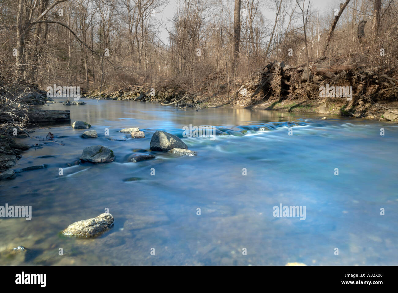 Long exposure of cool clear water running down a small river, Upstate ...