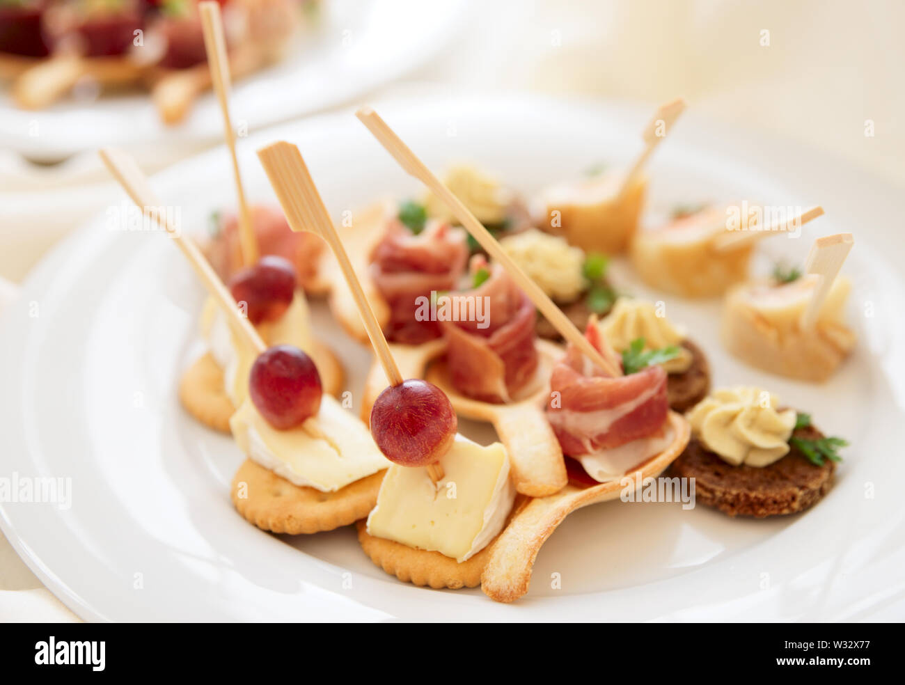 Canapes with cheese, ham and fruits, close-up shot Stock Photo - Alamy