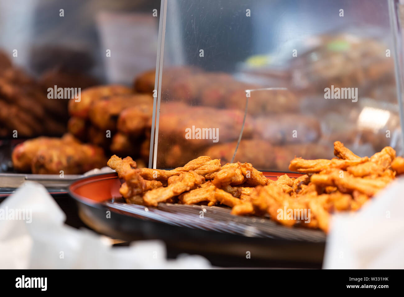 Closeup of retail display showing grill and battered fried grilled fish ...
