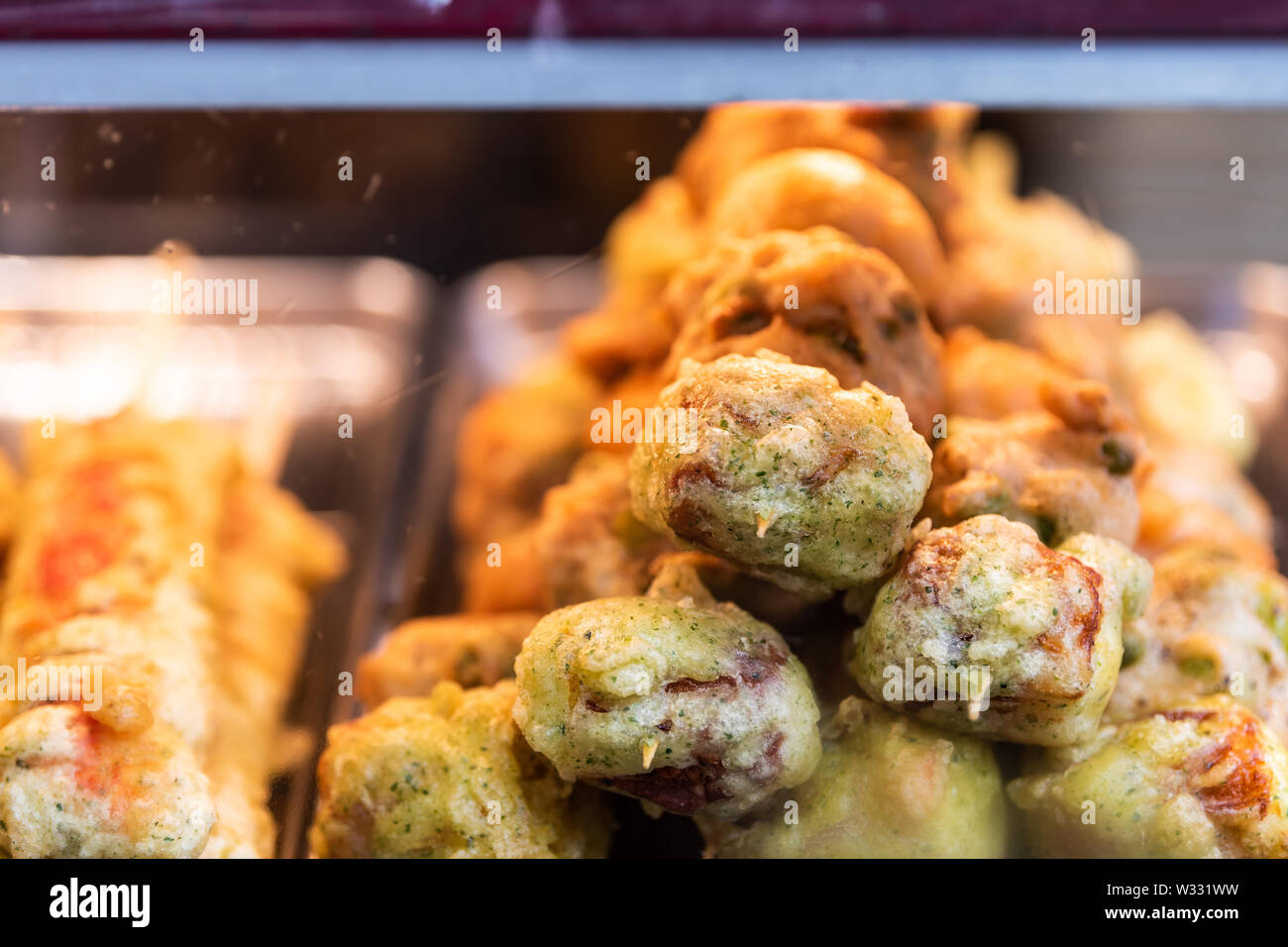 Retail store display of fried battered fish meat, crab balls and ...