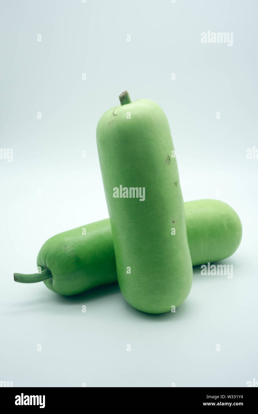 two green squash standing white background Stock Photo - Alamy