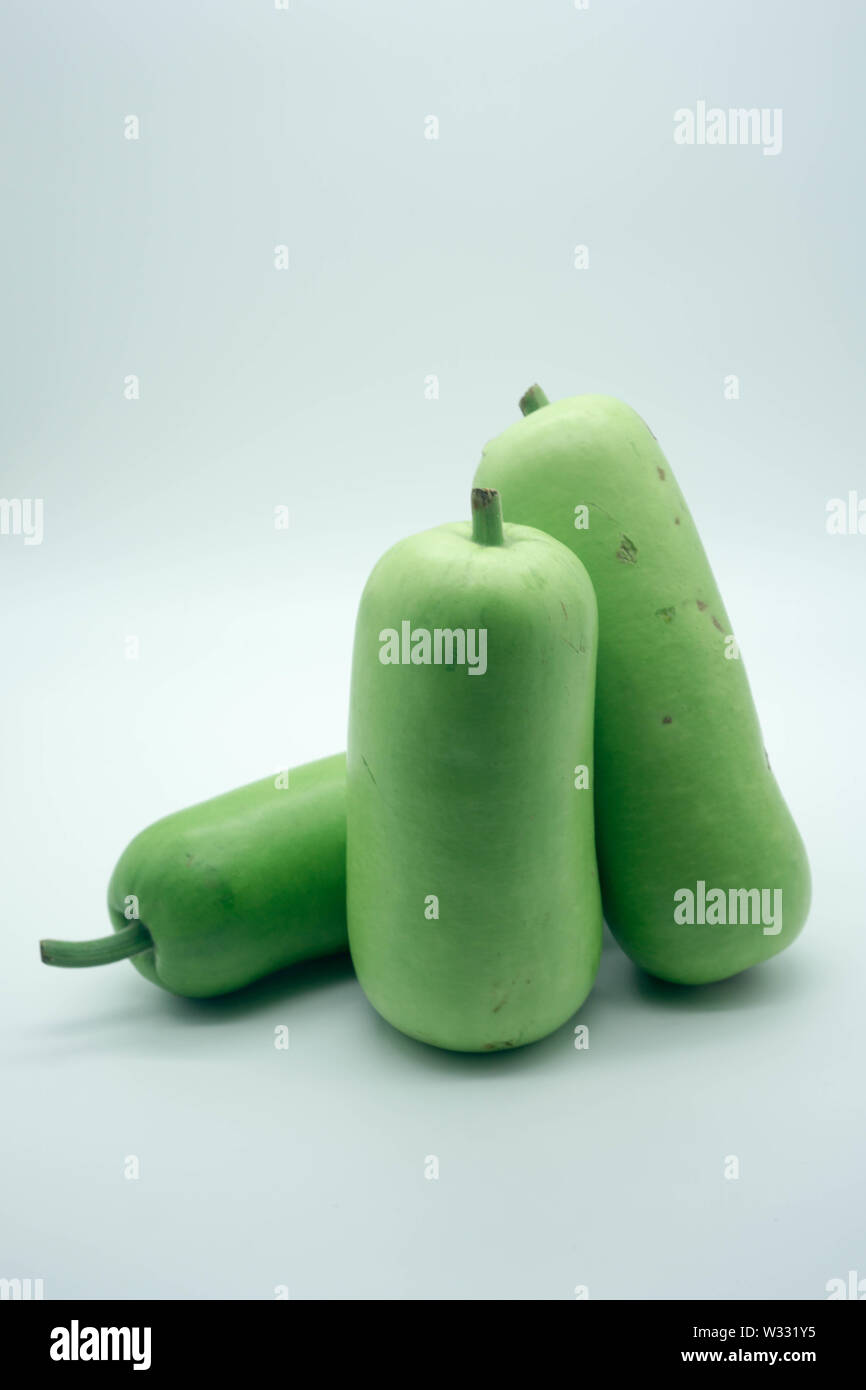 three green squash on a white background Stock Photo - Alamy