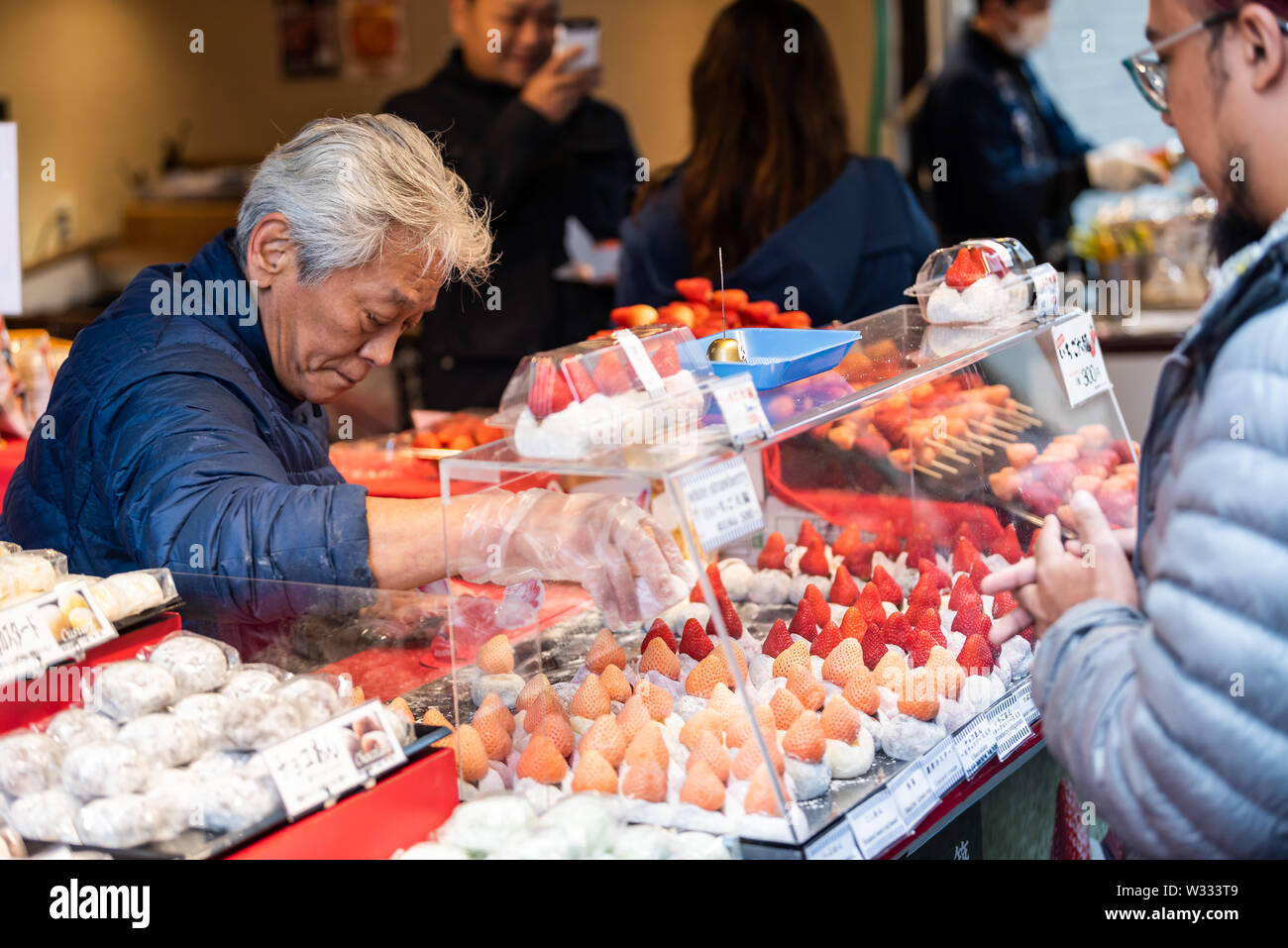 Tokyo, Japan - March 30, 2019: People buying mochi strawberries from ...