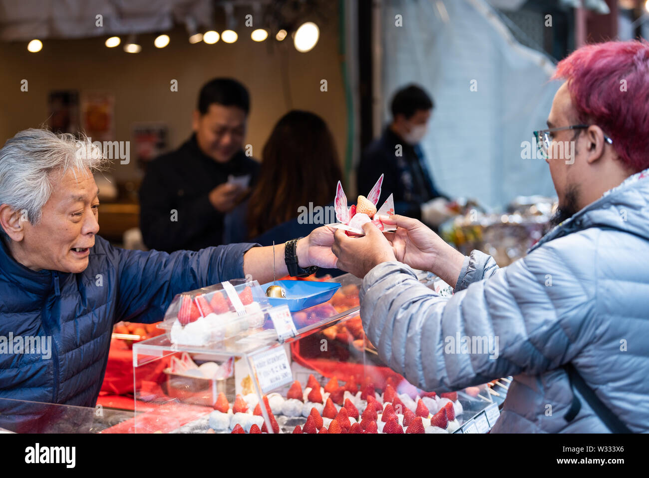 Tokyo, Japan - March 30, 2019: People buying mochi strawberries from ...