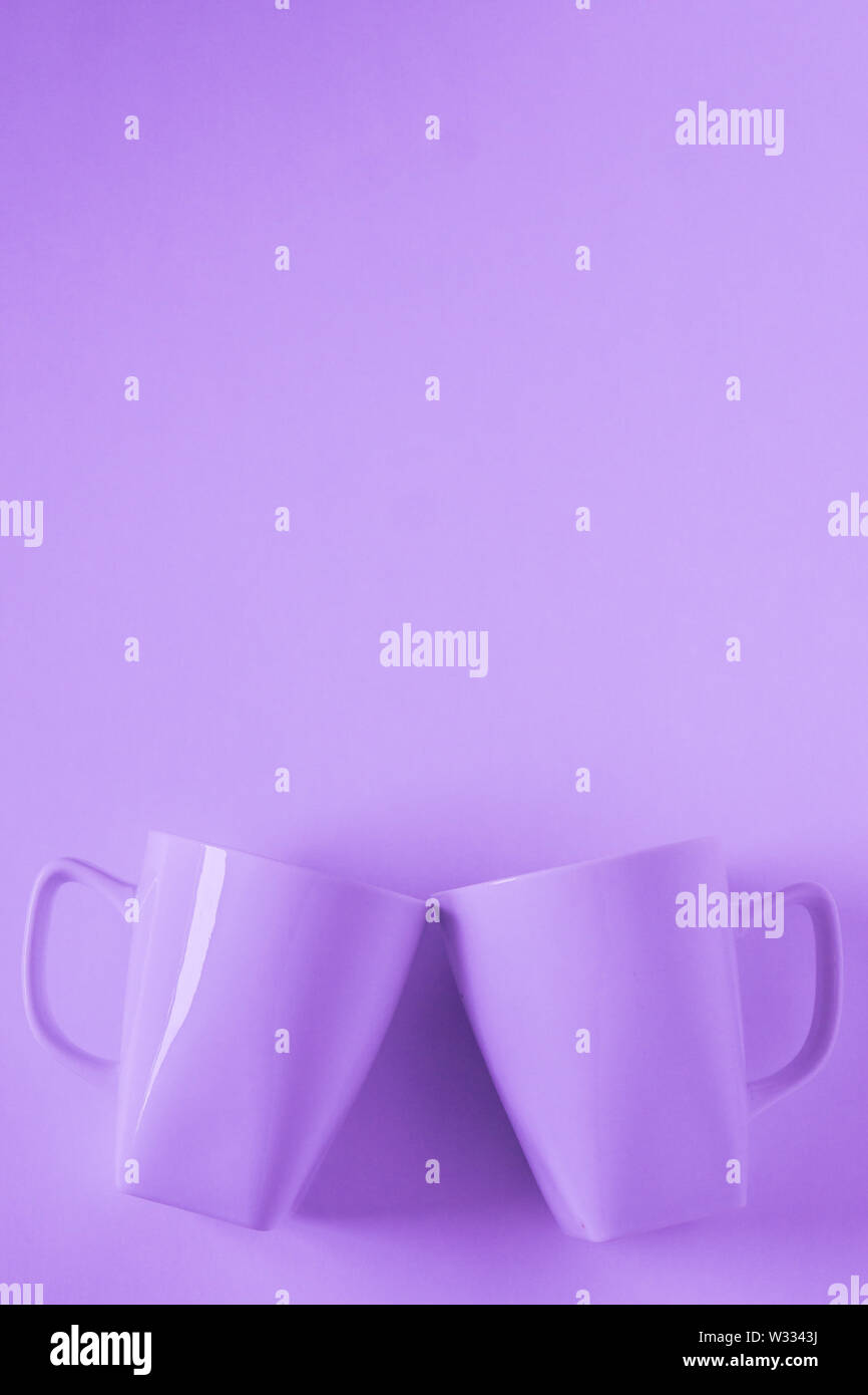 2 monochromatic purple coffee mugs, purplish background clinking in ...