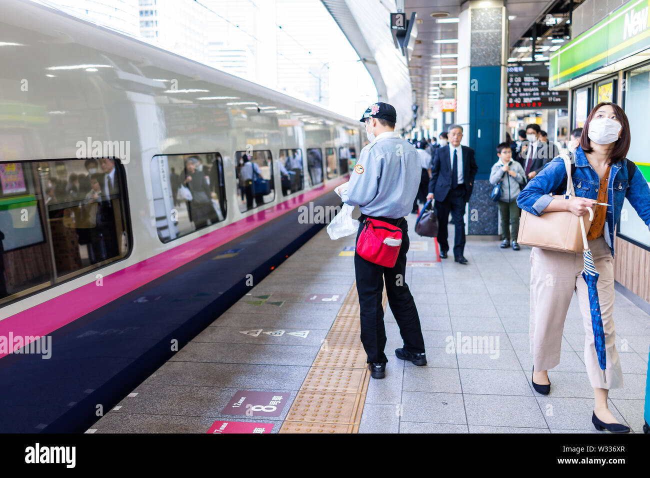 Tokyo, Japan - April 4, 2019: Japanese conductor worker on platform of ...