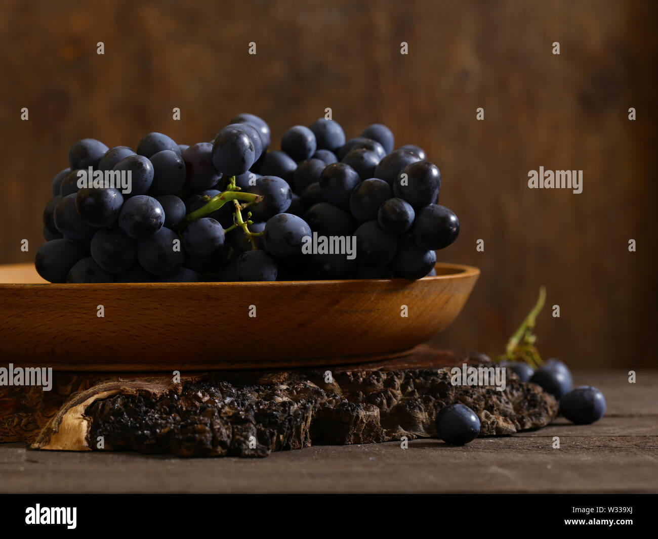 black ripe organic grapes on a wooden table, rustic style Stock Photo ...
