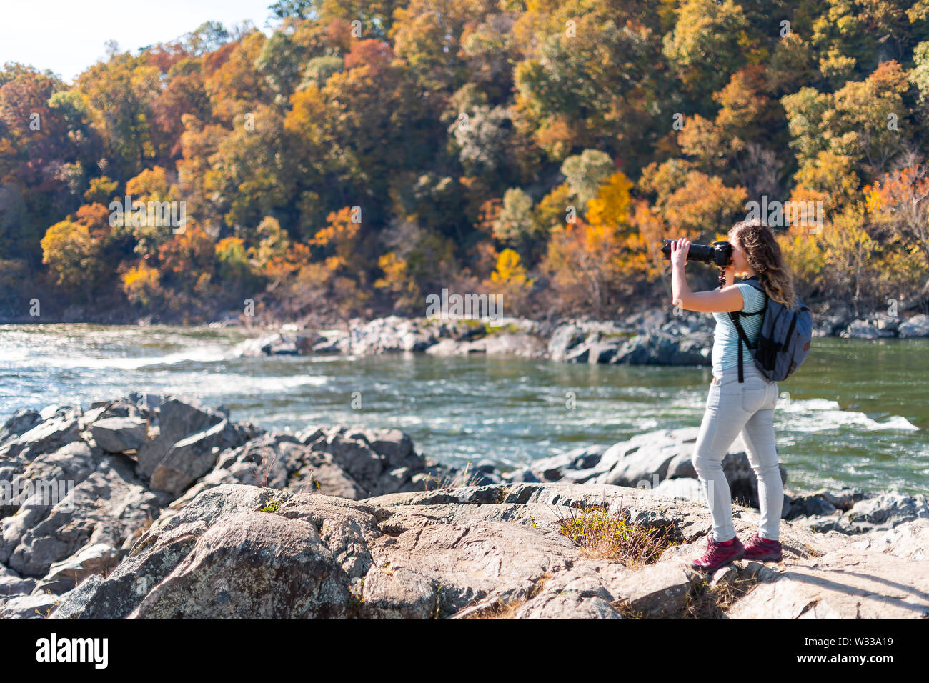 Young woman photographer taking photo picture with camera of view of ...