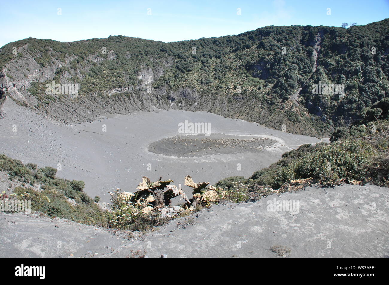 Irazu volcano in Costa Rica. Crater in clouds with protective barriers ...