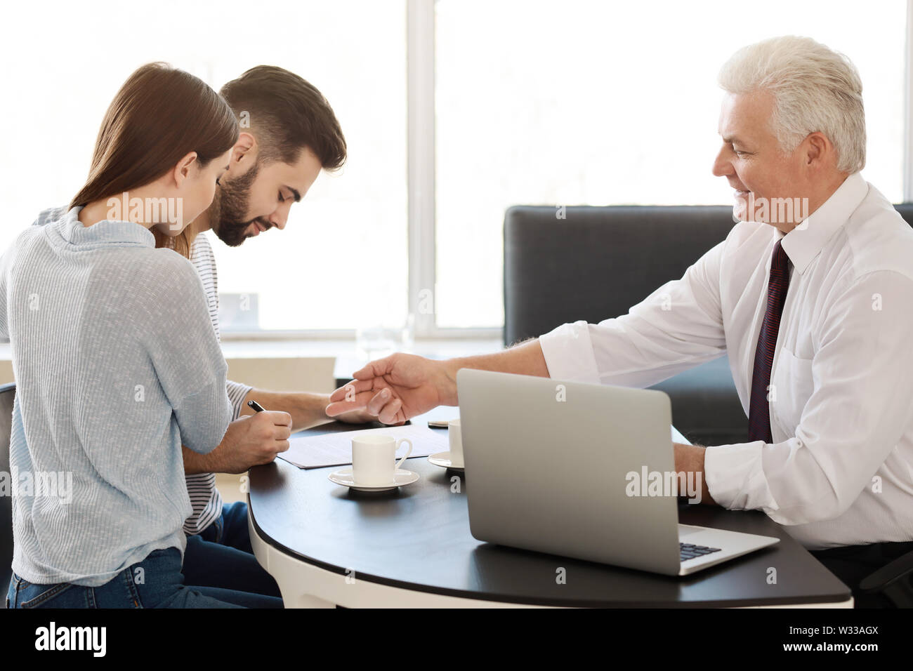 Couple signing documents at notary public office Stock Photo - Alamy