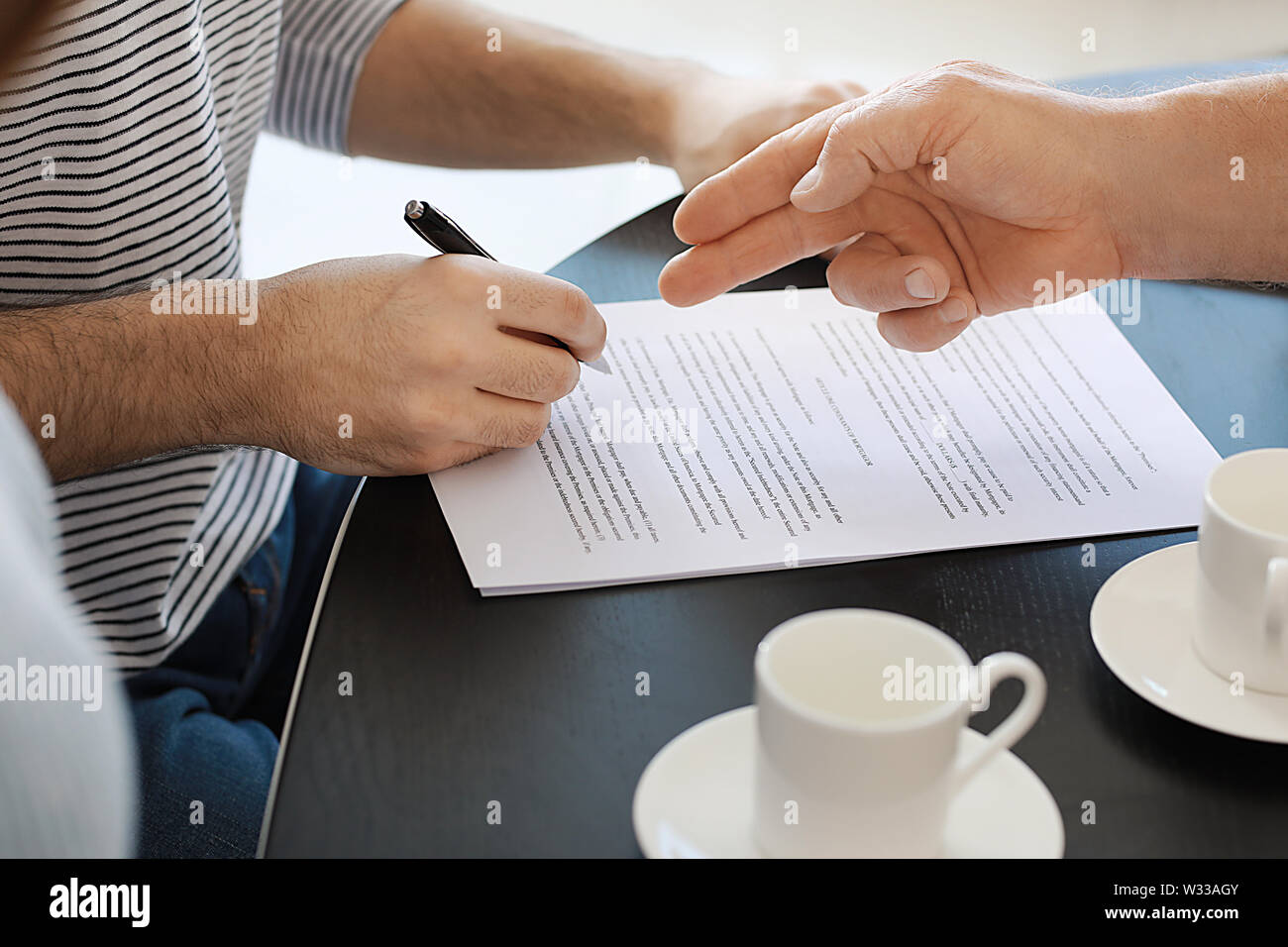 Man signing documents at notary public office, closeup Stock Photo - Alamy