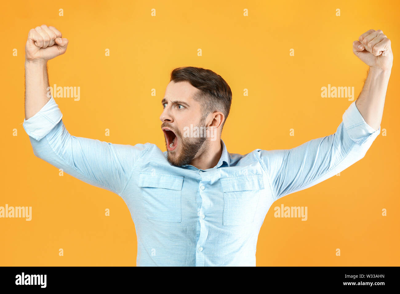 Happy successful handsome man on color background Stock Photo - Alamy