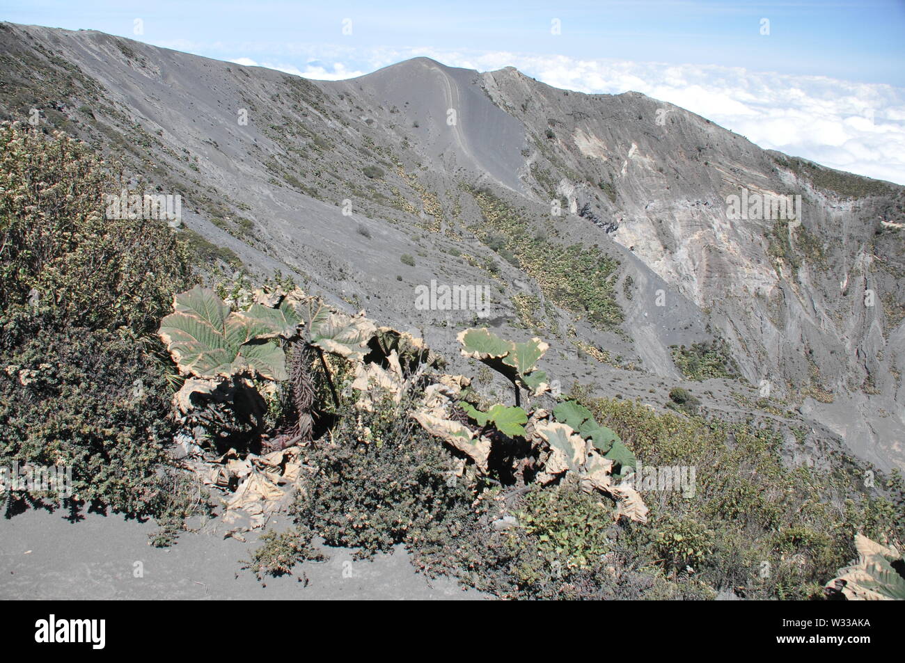 Irazu volcano in Costa Rica. Crater in clouds with protective barriers ...