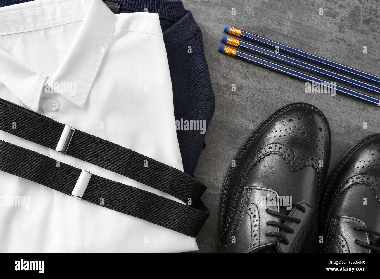 School uniform and stationery on grey background Stock Photo - Alamy