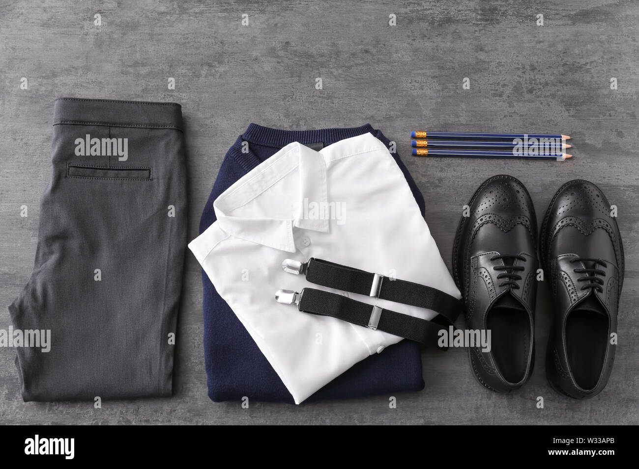 School uniform and stationery on grey background Stock Photo - Alamy