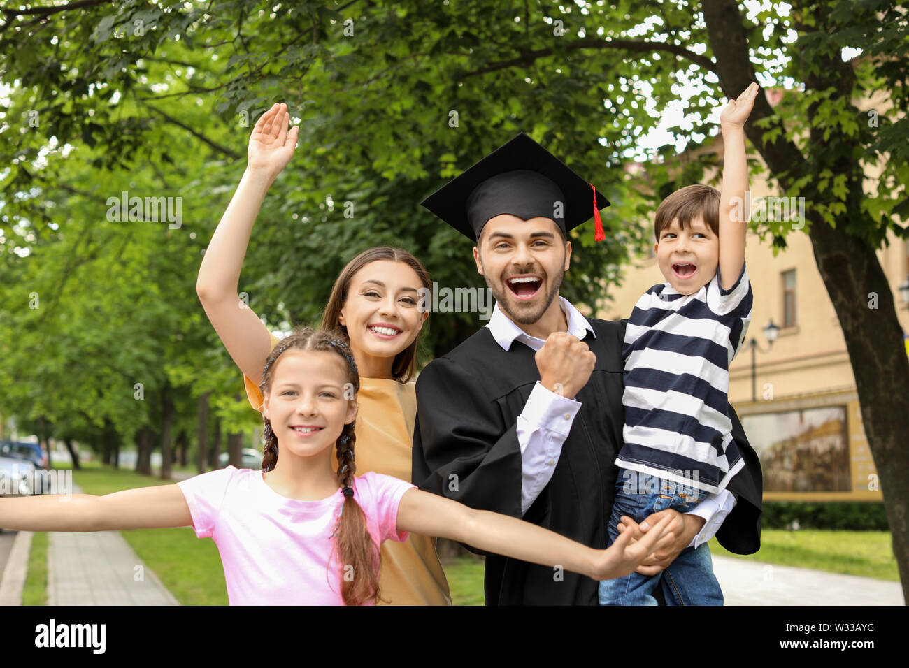Happy man with his family on graduation day Stock Photo - Alamy
