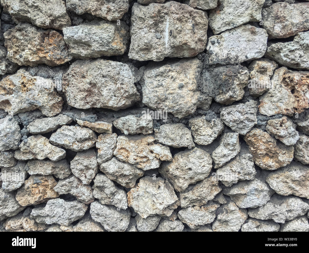 Closeup rough big stones wall texture background Stock Photo - Alamy