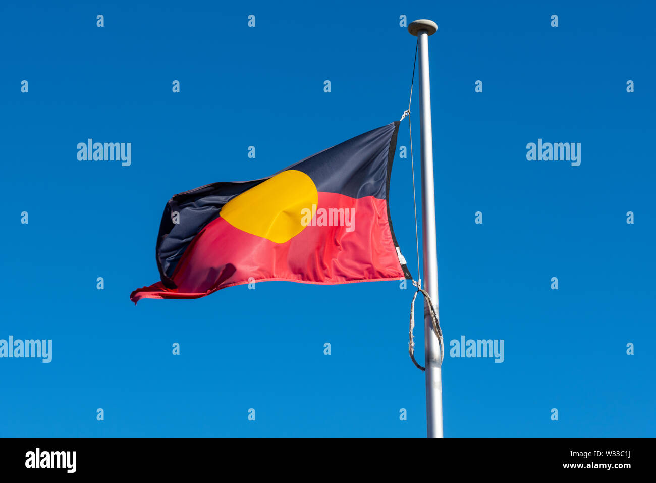 the australian aboriginal indigenous flag flying in the wind Stock ...