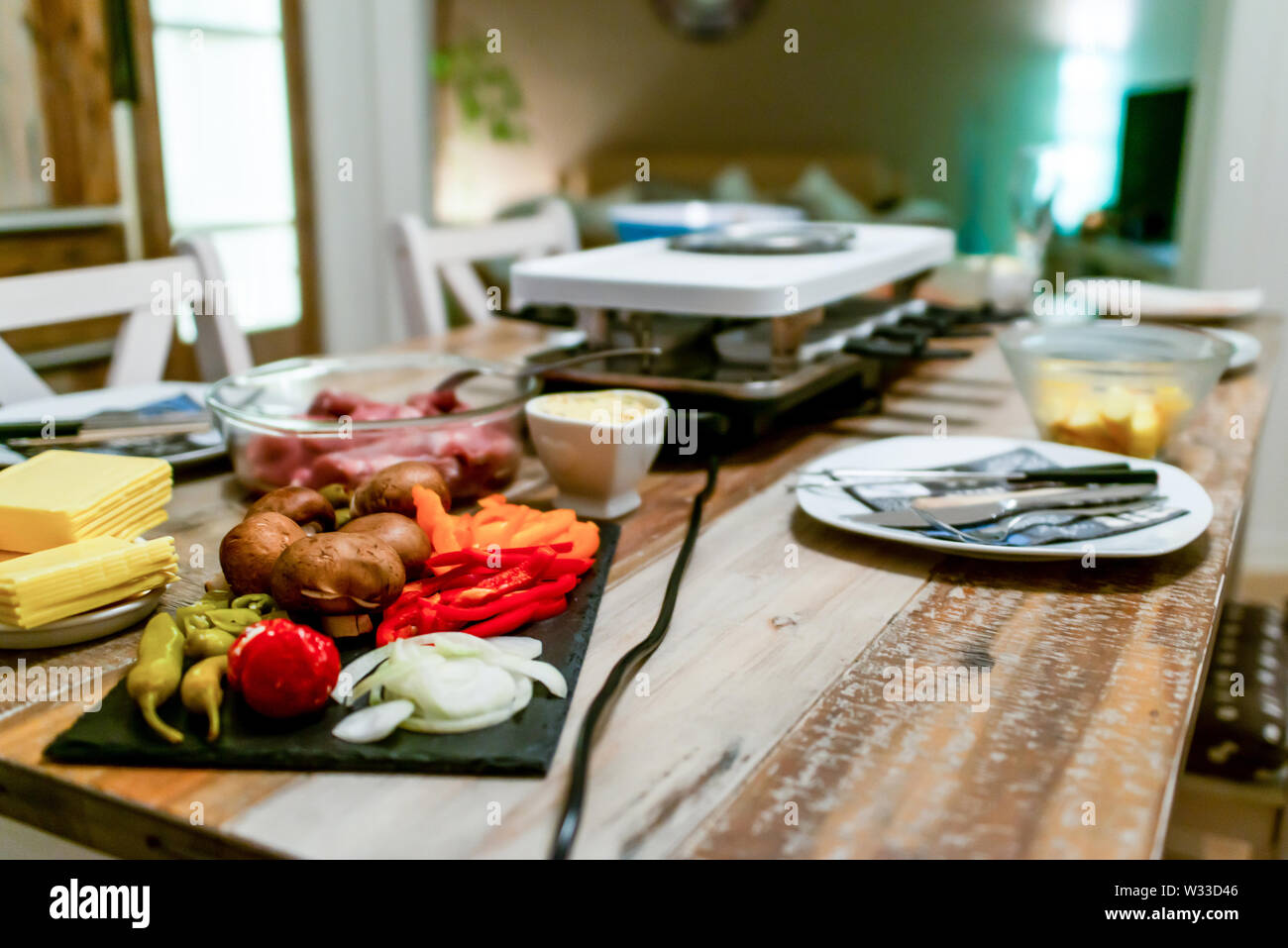 Swiss or Dutch raclette table filled with ingredients for a celebratory ...