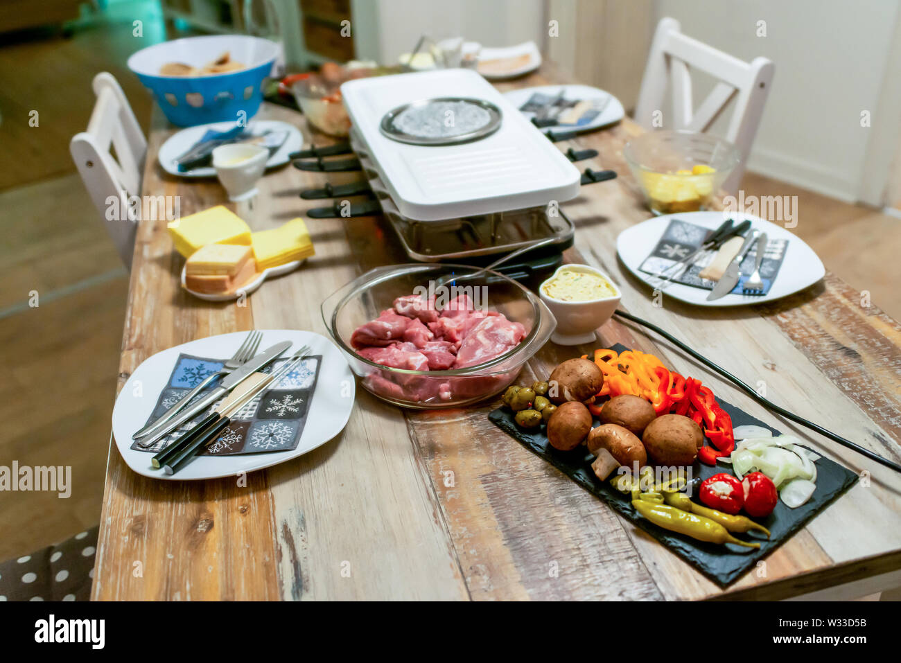 Swiss or Dutch raclette table filled with ingredients for a celebratory ...