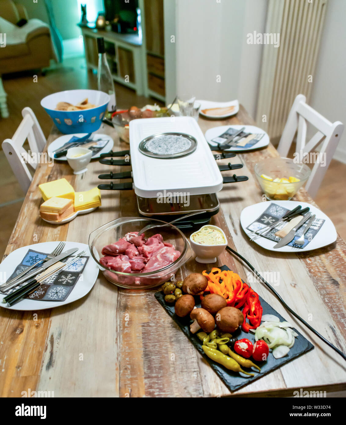Swiss or Dutch raclette table filled with ingredients for a celebratory ...